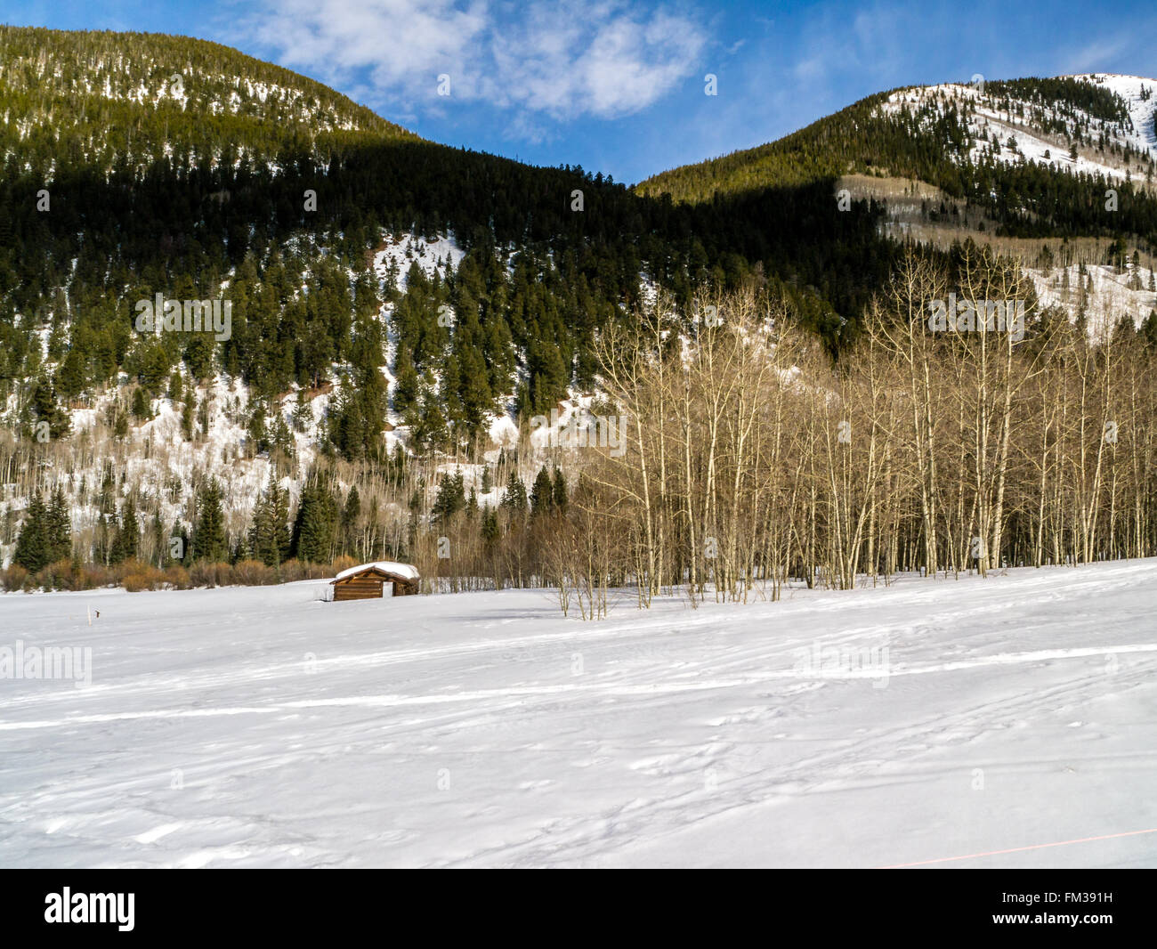 Solitary old cabin alone in the mountains under a blue sky Stock Photo ...