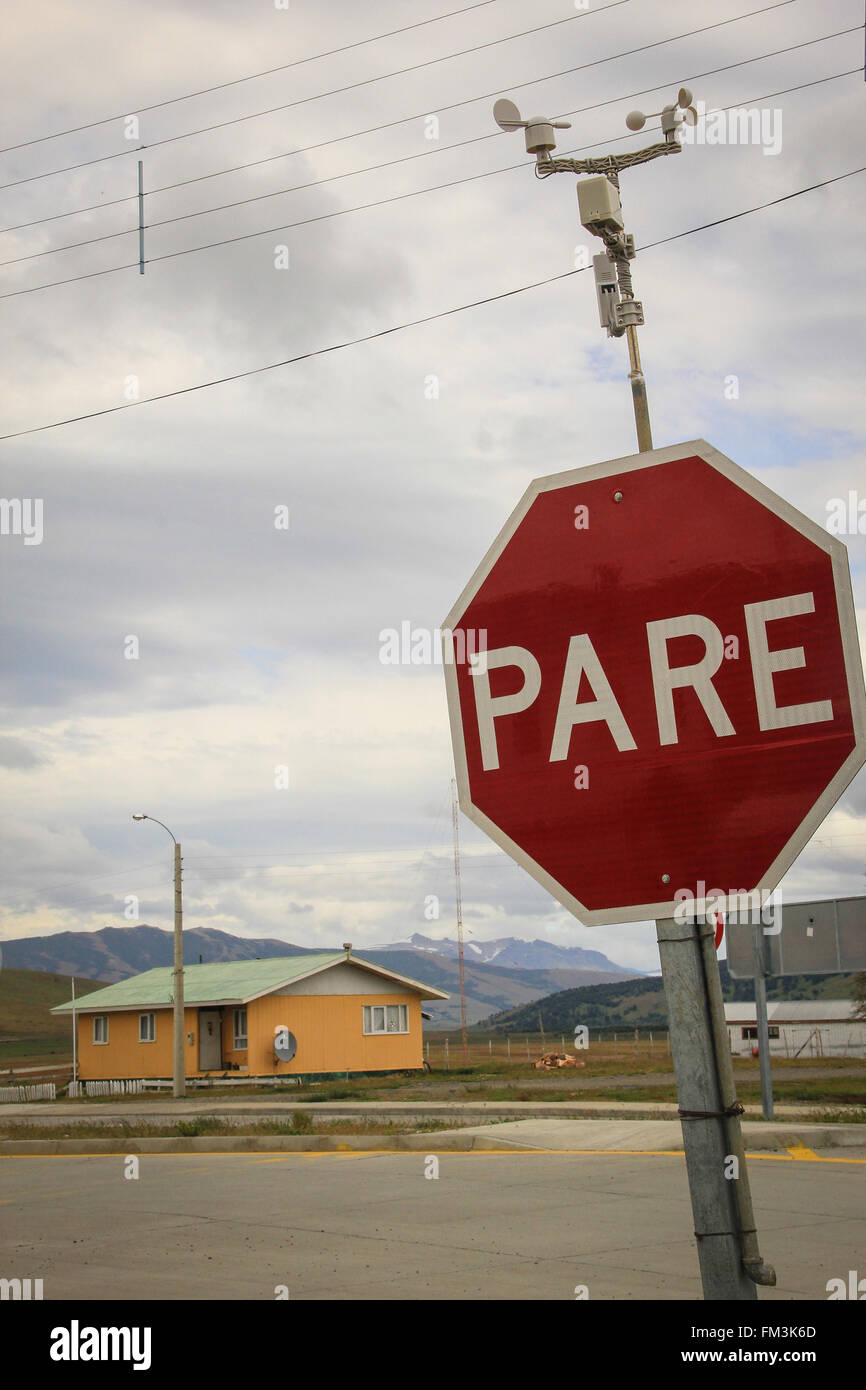 Stop sign with yellow house behind Stock Photo - Alamy