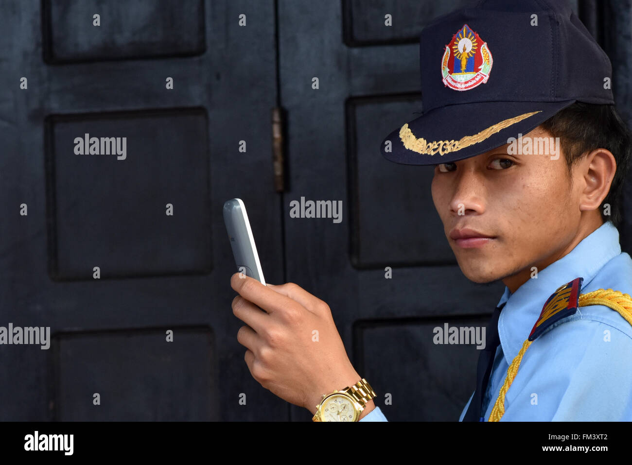 Security guard and mobile phone Laos Stock Photo - Alamy