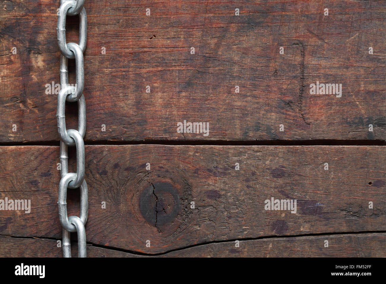 White metal chain on nice old wooden background Stock Photo - Alamy