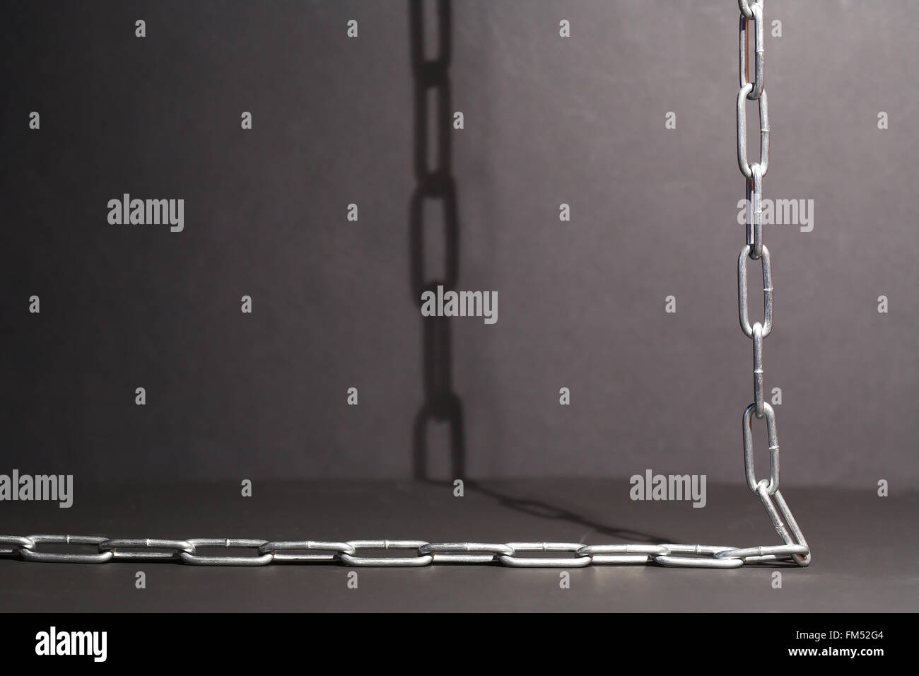 Metal chain with shadow on dark background Stock Photo - Alamy