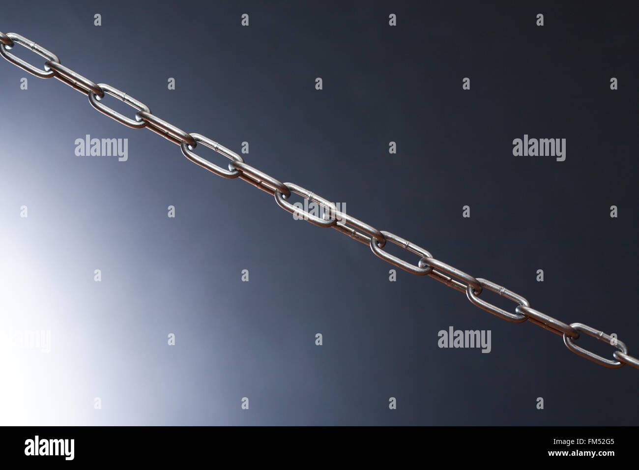 Metal chain closeup on nice dark background Stock Photo - Alamy