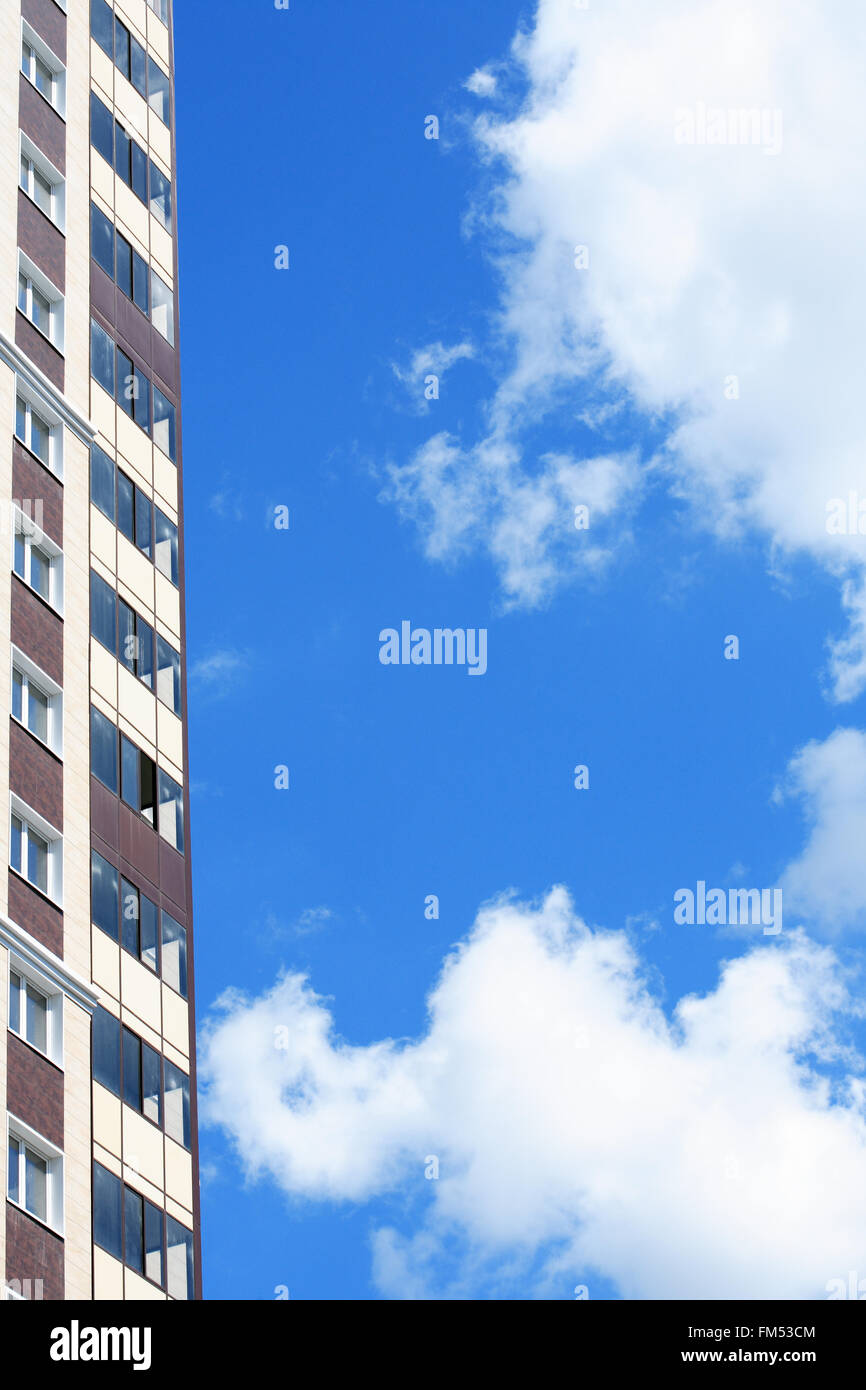 New modern building against blue sky with white clouds Stock Photo - Alamy