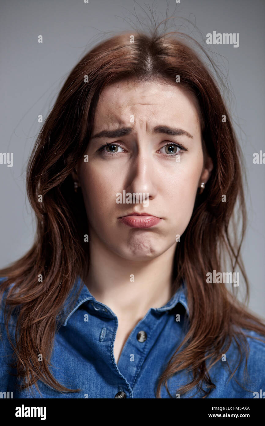 The portrait of a beautiful sad girl closeup on gray Stock Photo - Alamy