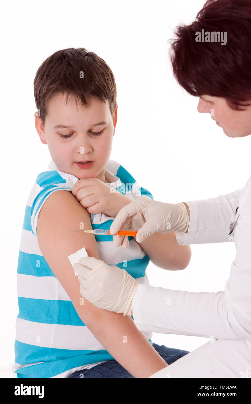 Doctor giving a child injection in arm on isolated image Stock Photo ...