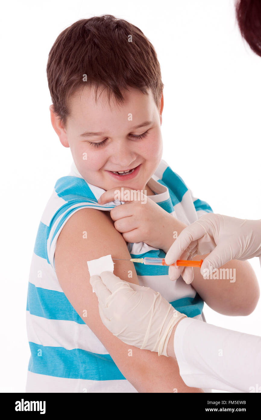 Doctor giving a child injection in arm on isolated image Stock Photo ...