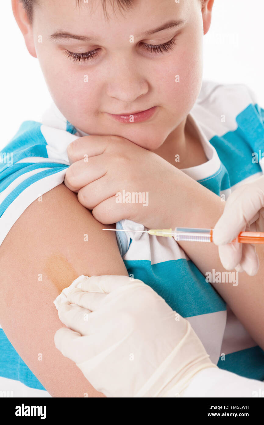 Doctor giving a child injection in arm on isolated image Stock Photo ...