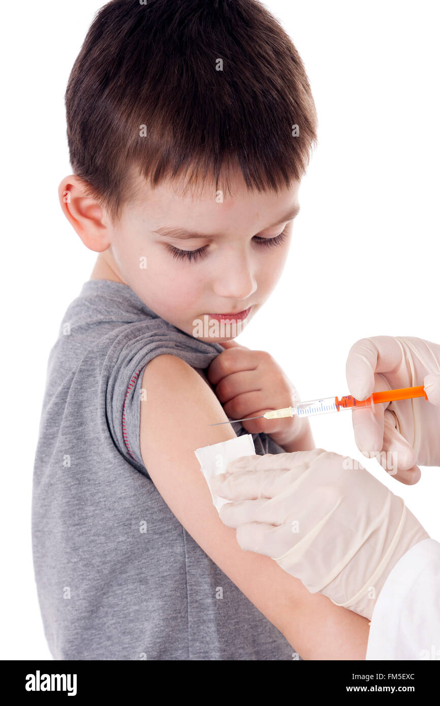 Doctor giving a child injection in arm on isolated image Stock Photo ...