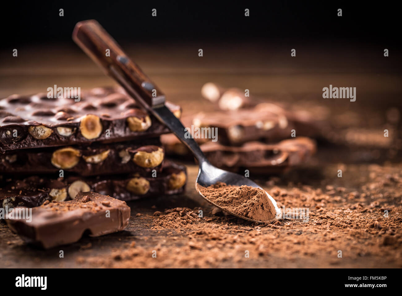 Cocoa powder on spoon, chocolate in background Stock Photo - Alamy