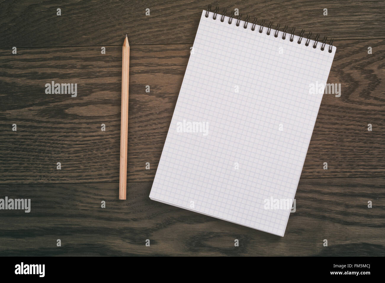 notepad with pencil on wood table Stock Photo - Alamy