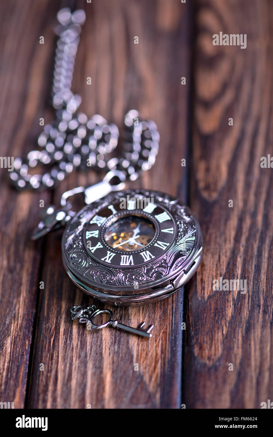 Vintage pocket watch and hour glass or sand timer, symbols of time with ...