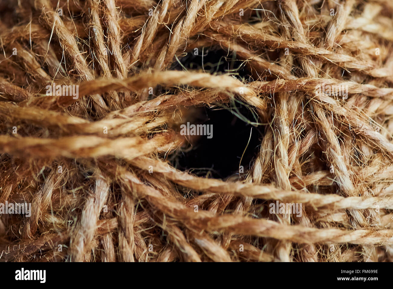 A roll of natural brown rope , background Stock Photo - Alamy