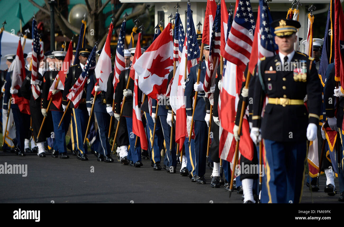Honor guards carry US and Canadian flags at the White House as part of ...