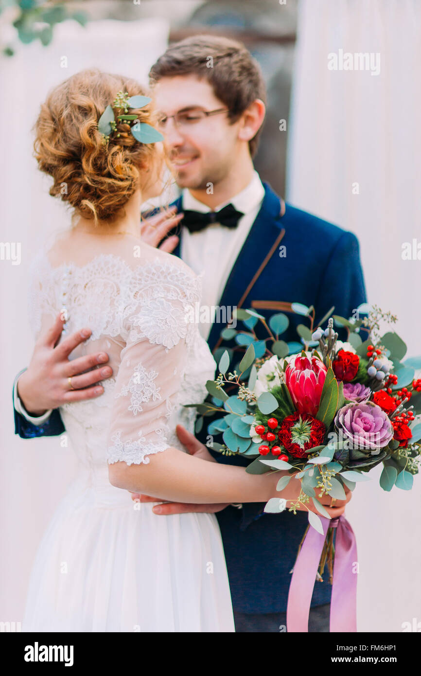 Gorgeous wedding couple lovingly hugging on white background Stock ...