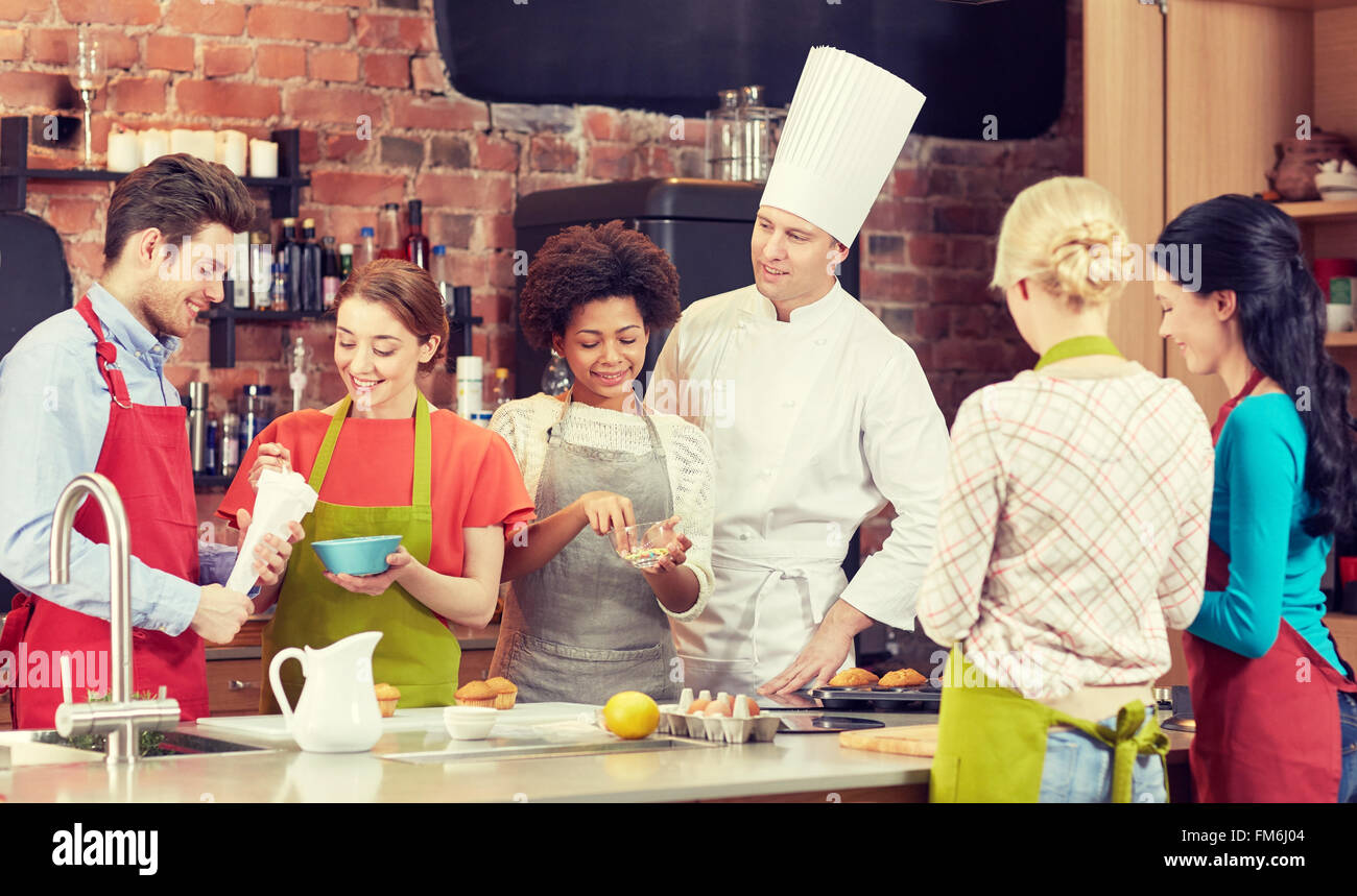 happy friends and chef cook cooking in kitchen Stock Photo - Alamy