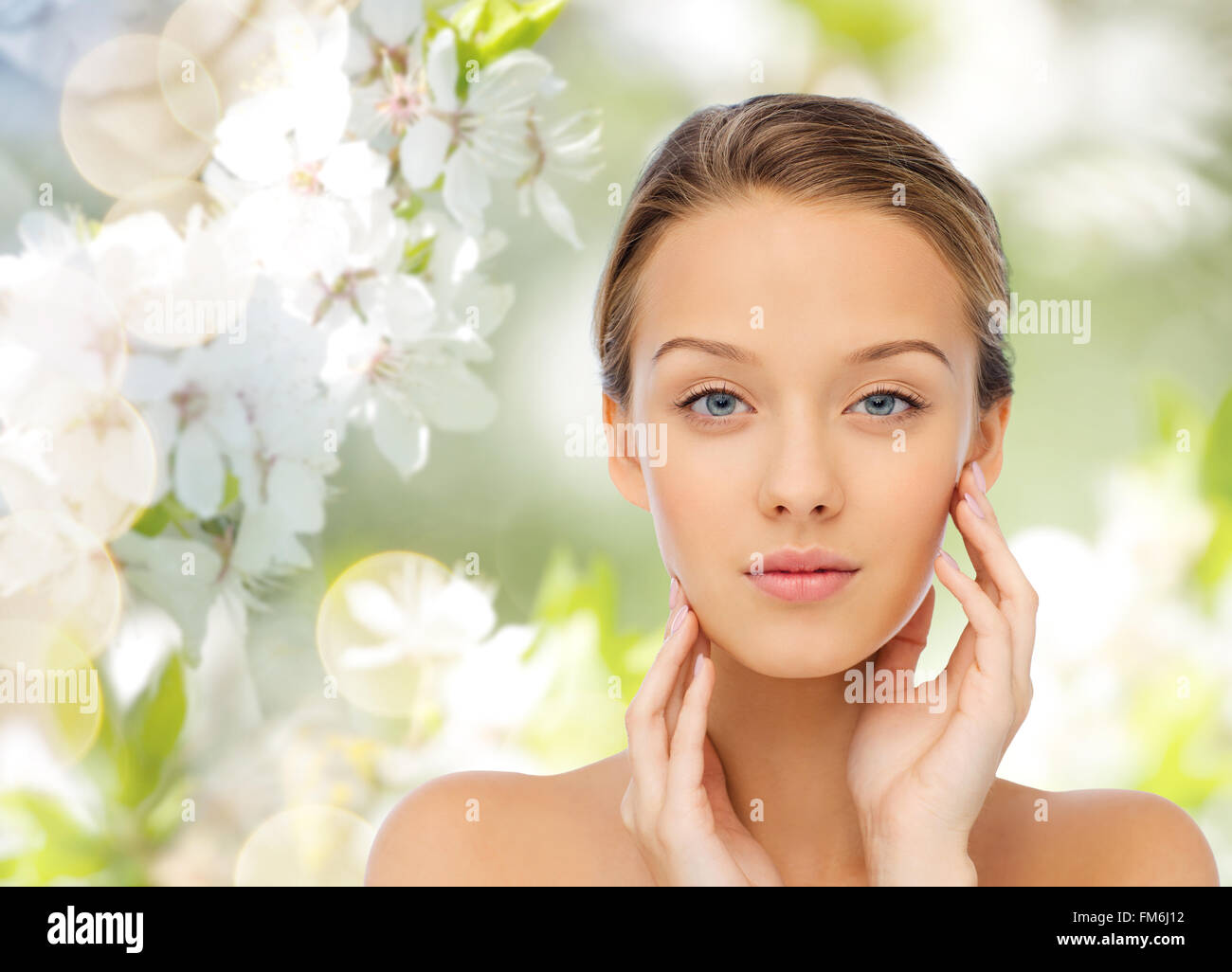 young woman touching her face Stock Photo - Alamy