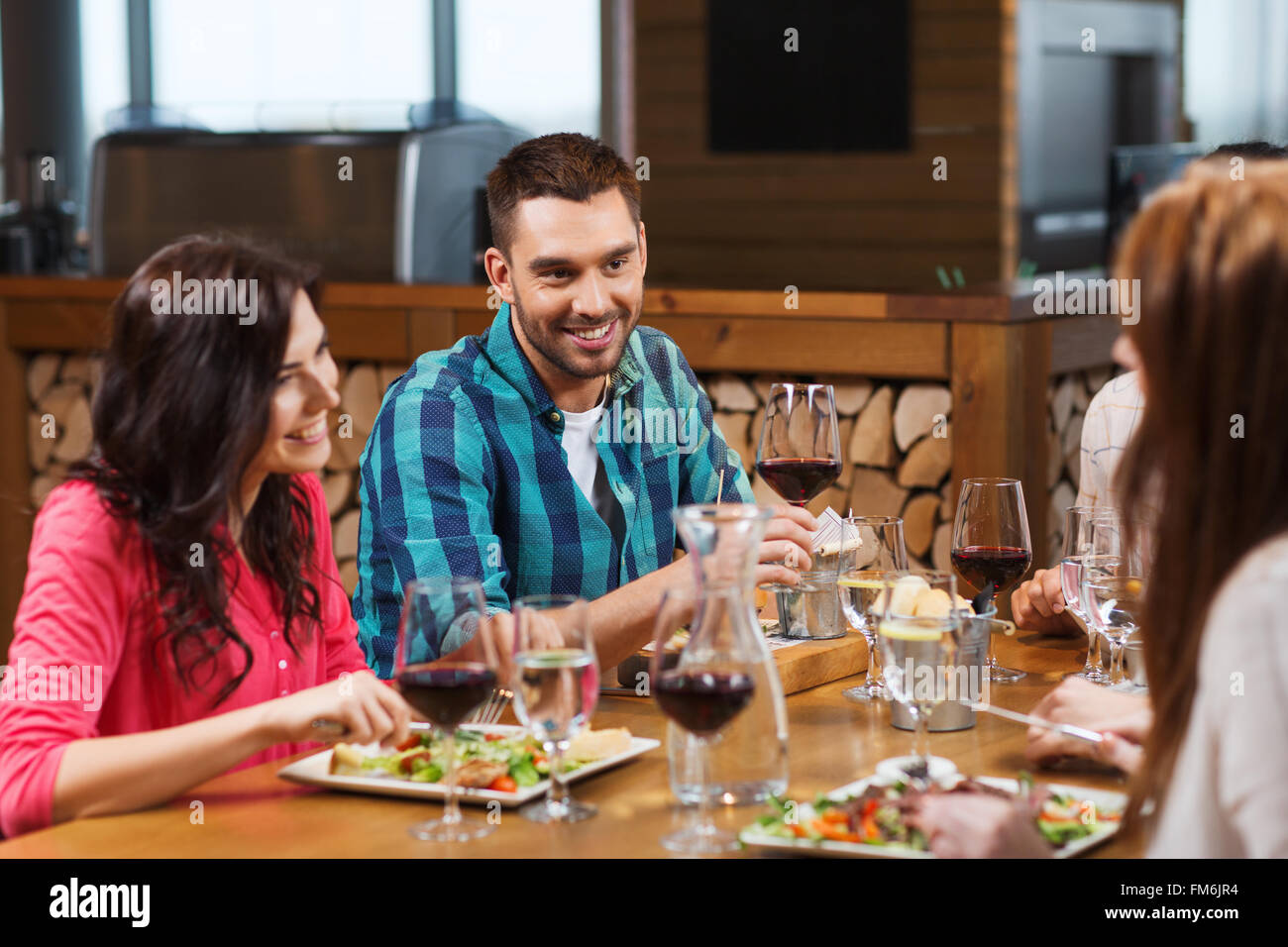 friends dining and drinking wine at restaurant Stock Photo - Alamy