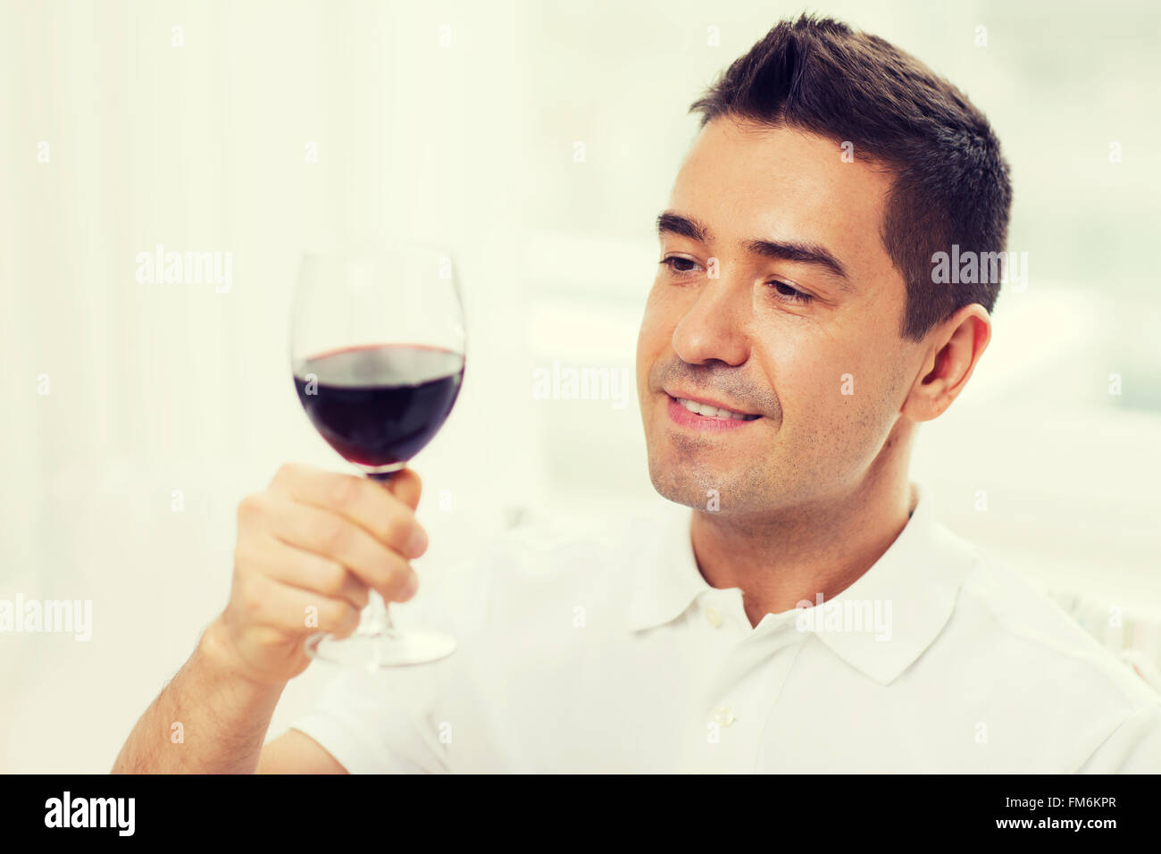 happy man drinking red wine from glass at home Stock Photo - Alamy