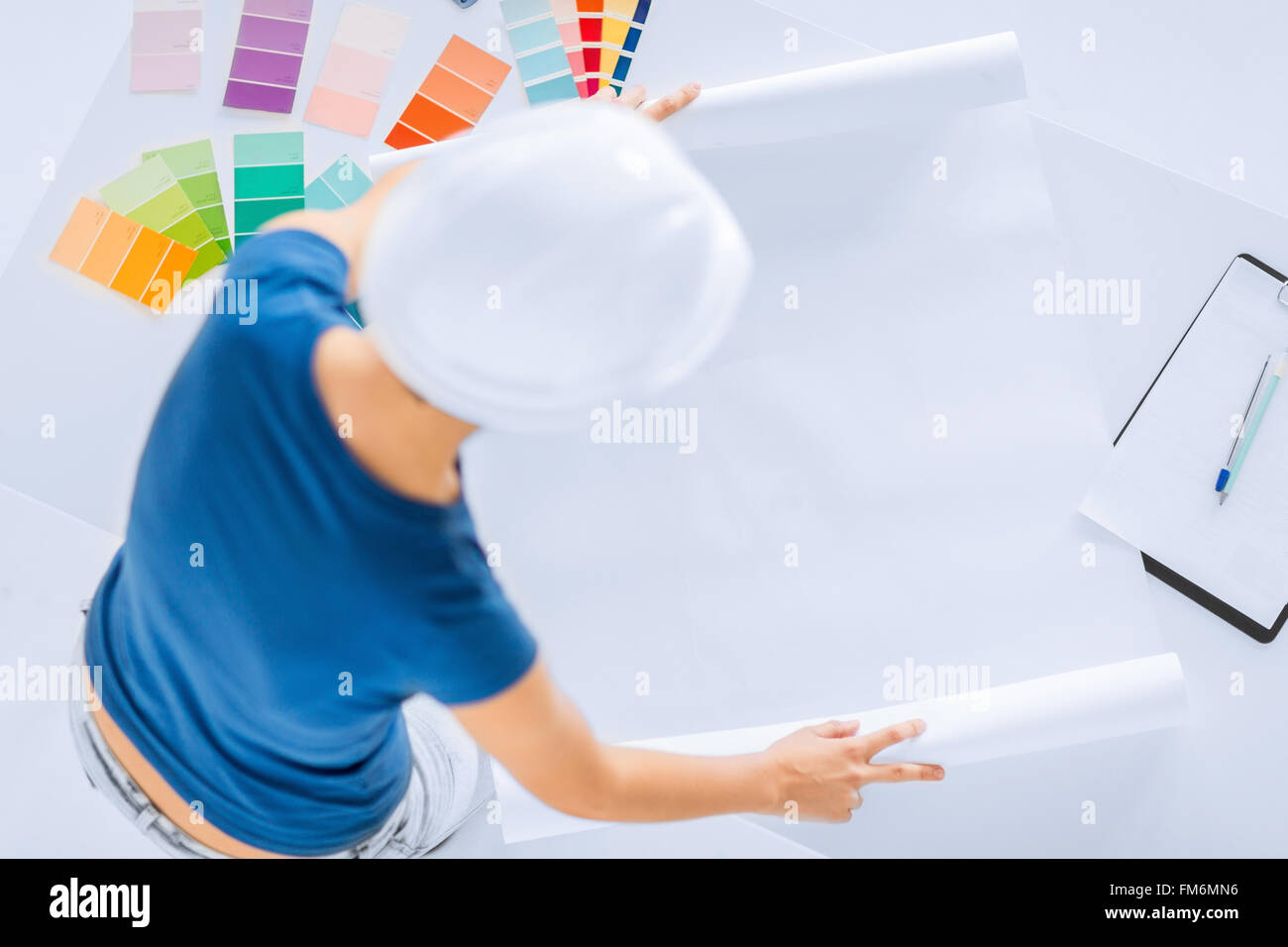 woman with color samples and blueprint Stock Photo - Alamy