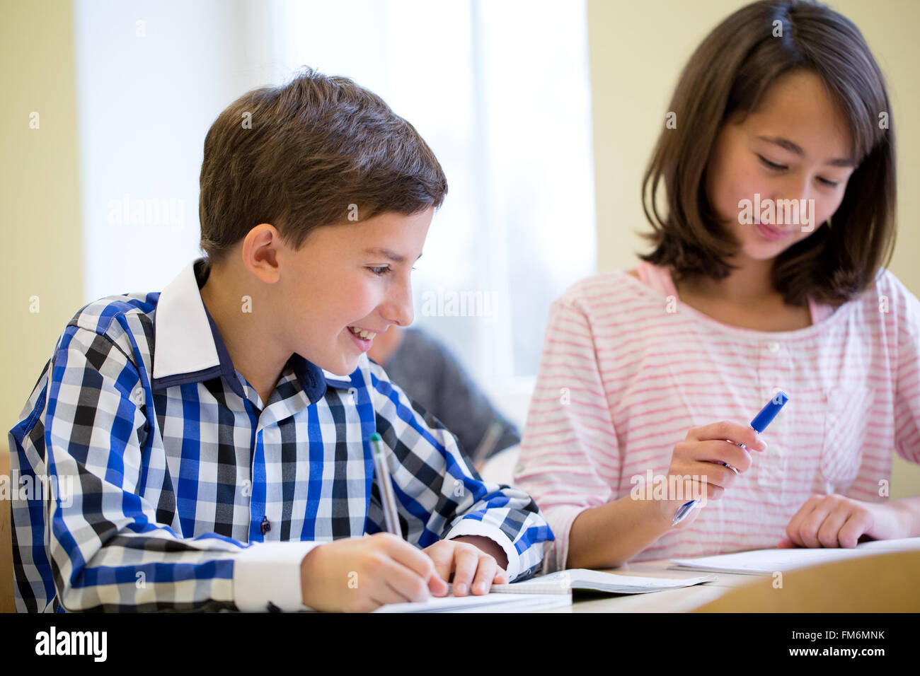 group of school kids writing test in classroom Stock Photo - Alamy