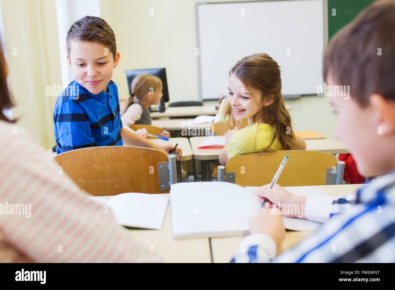 group of school kids writing test in classroom Stock Photo - Alamy