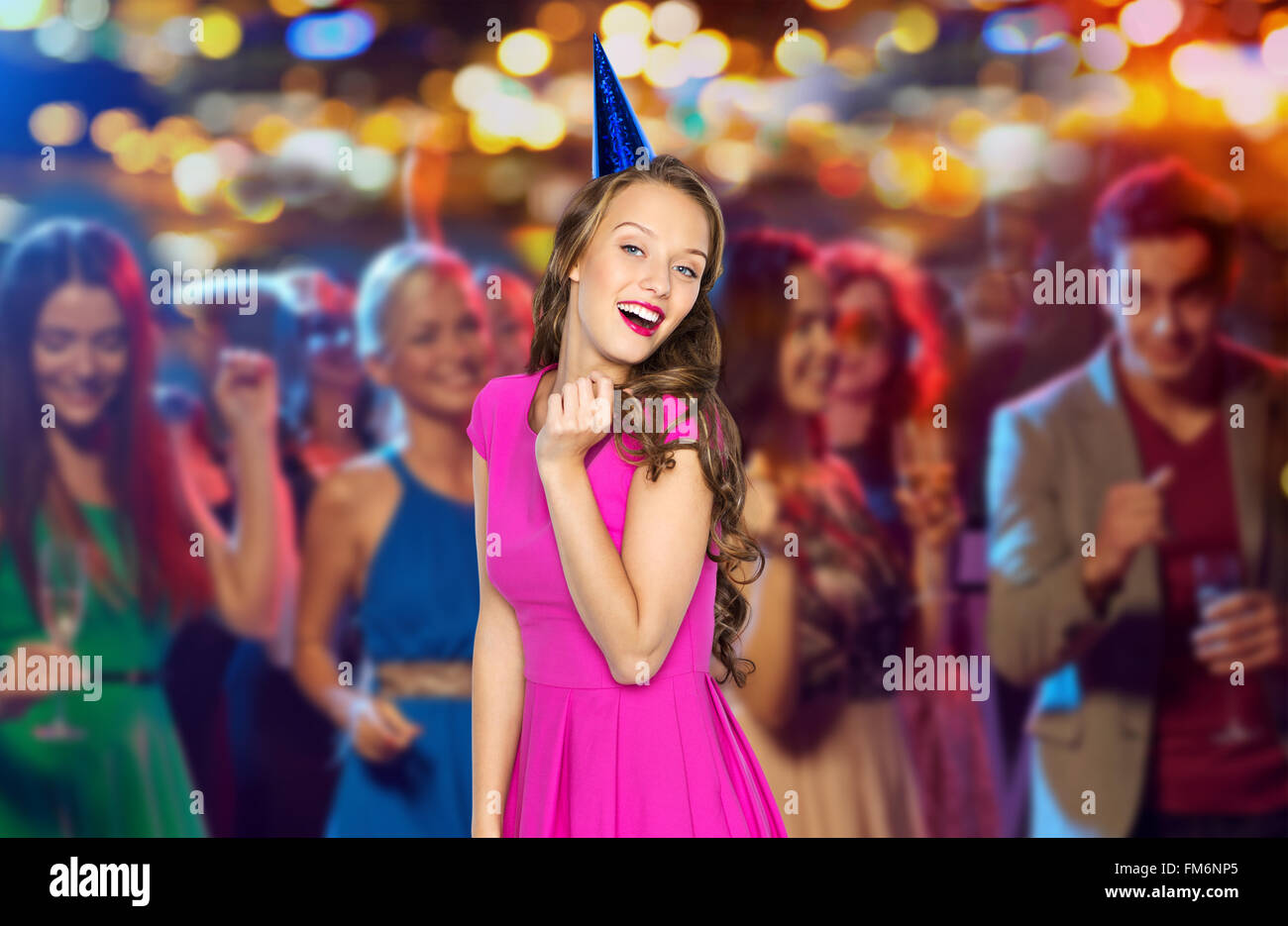 happy woman or teen in party cap at night club Stock Photo - Alamy