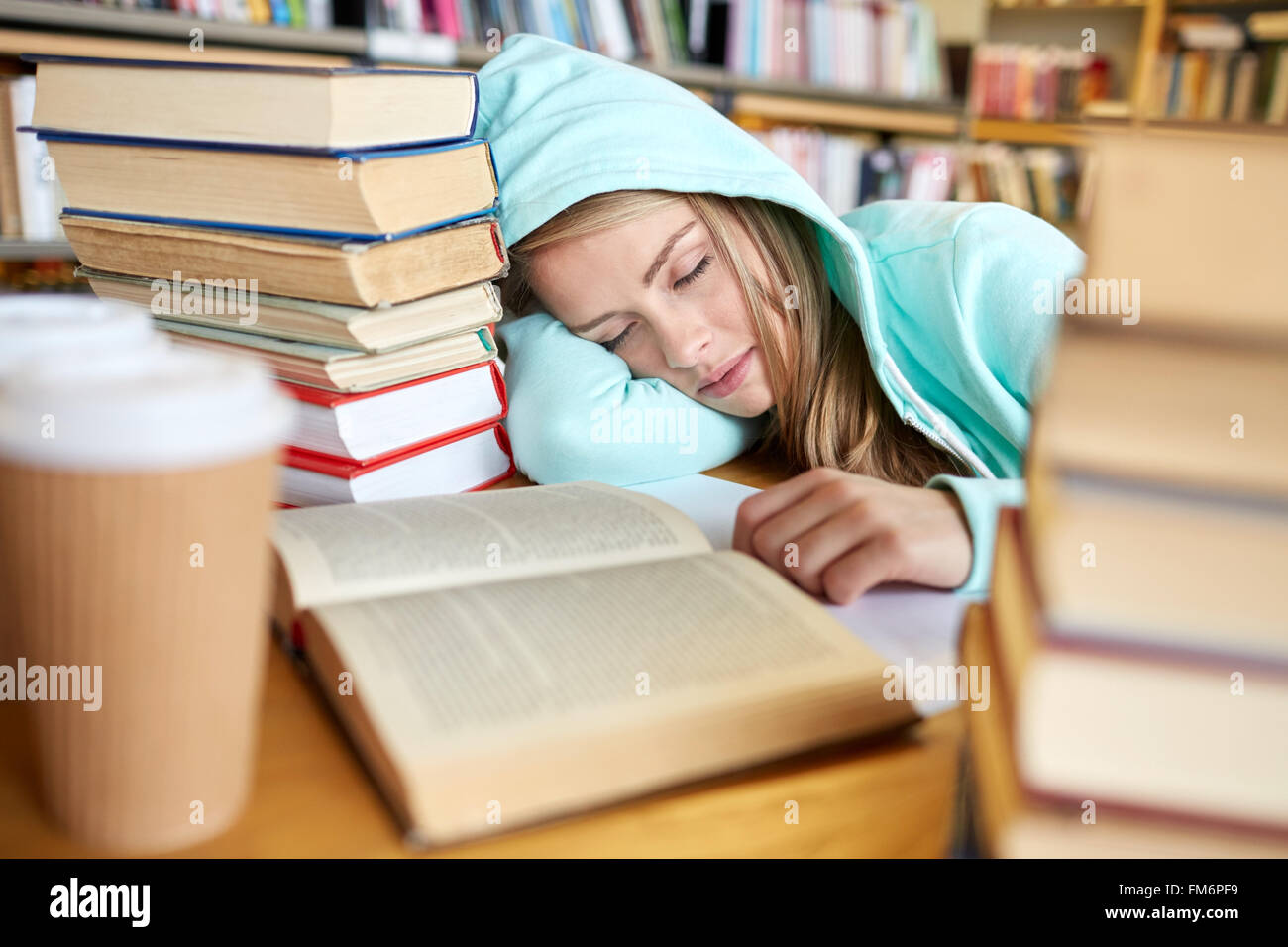 student or woman with books sleeping in library Stock Photo - Alamy