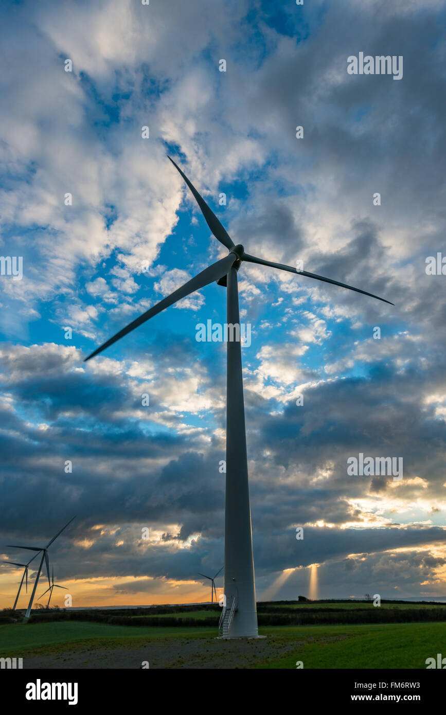 Wind turbine against a dramatic sky with sun rays coming through. North ...