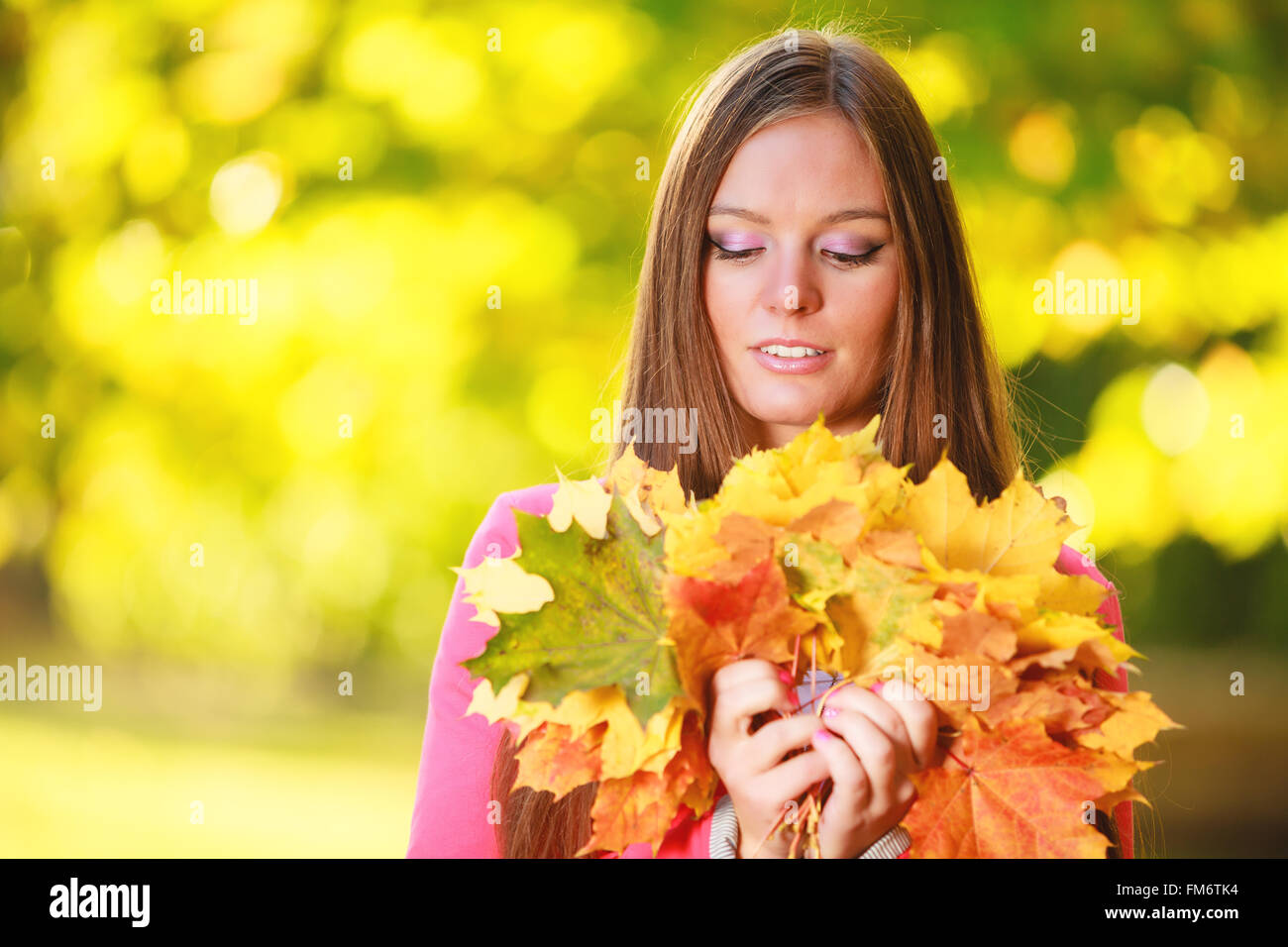 Fall season. Portrait of happy girl young woman with bunch of colorful ...