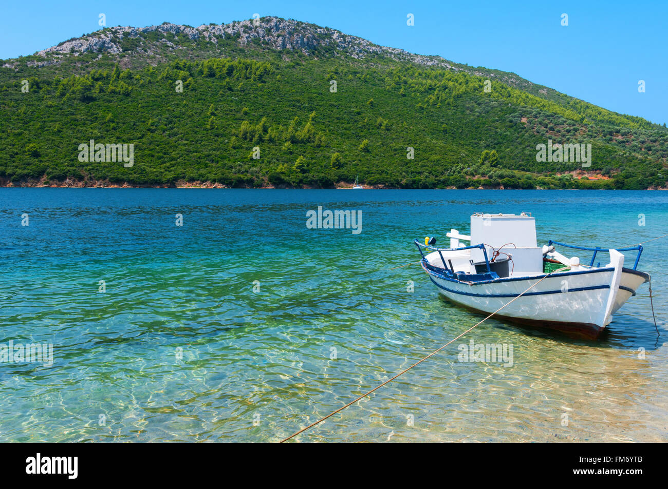 A fishing boat anchored in a small bay Stock Photo - Alamy