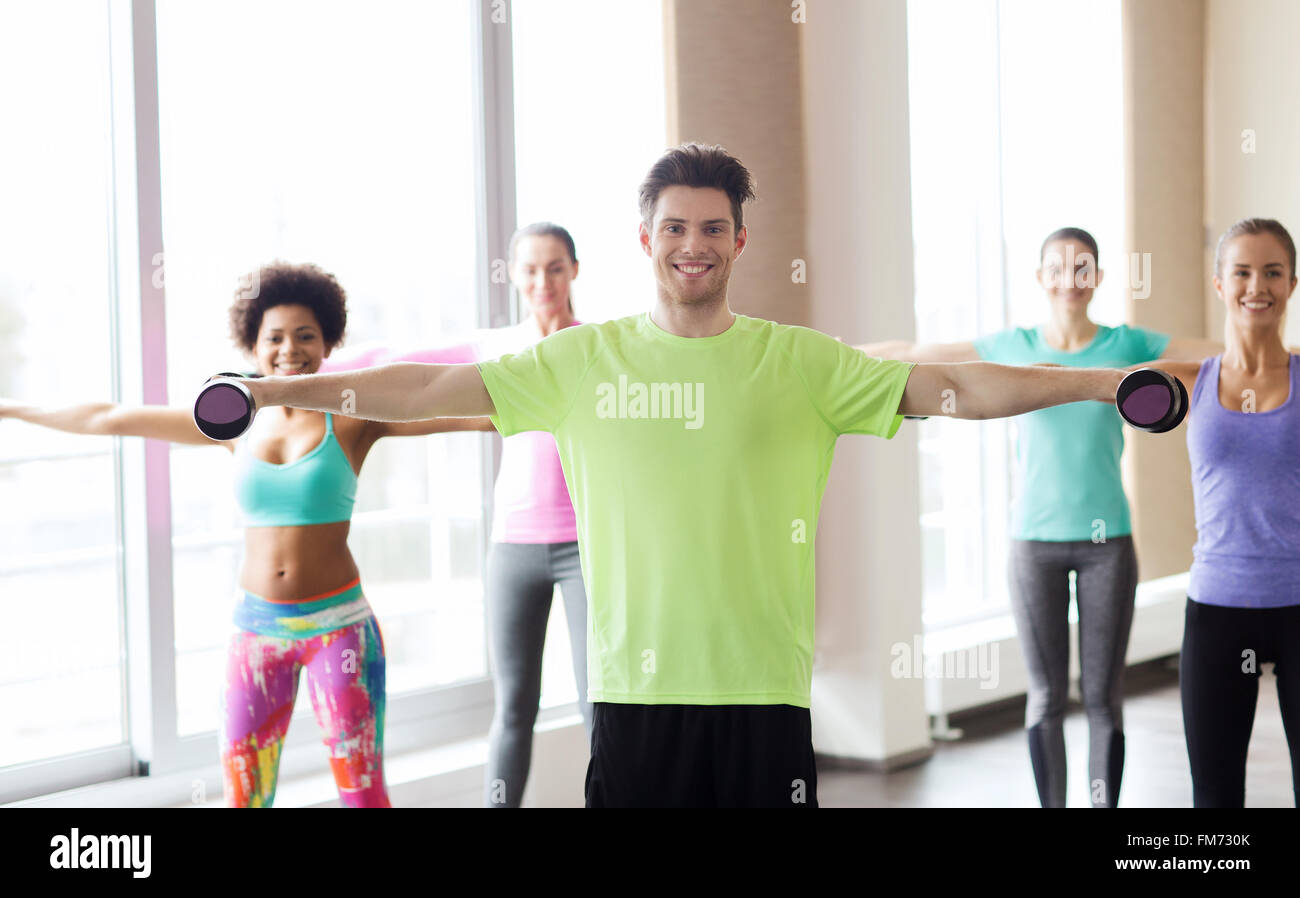group of smiling people working out with dumbbells Stock Photo - Alamy