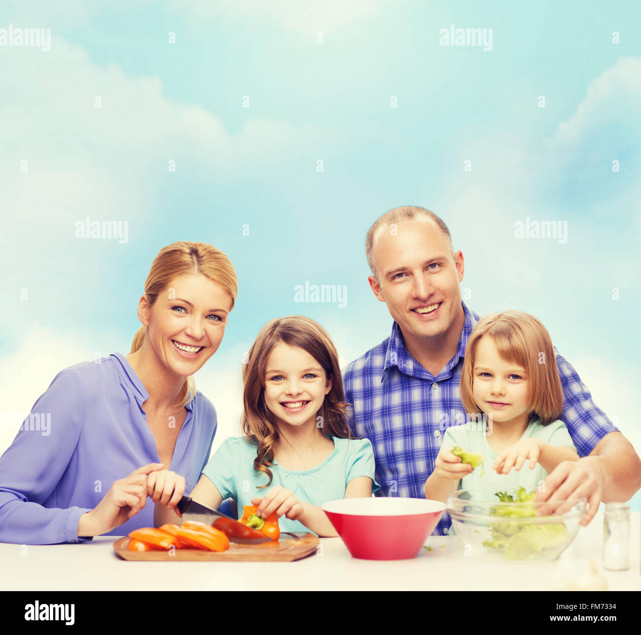 happy family with two kids making dinner at home Stock Photo - Alamy