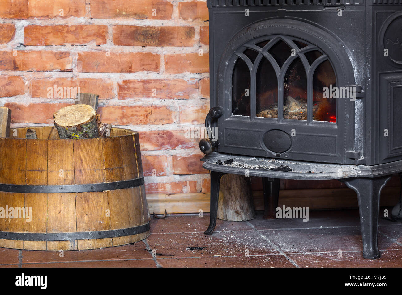Winter at home. Closeup of fireplace with orange fire flame and ...
