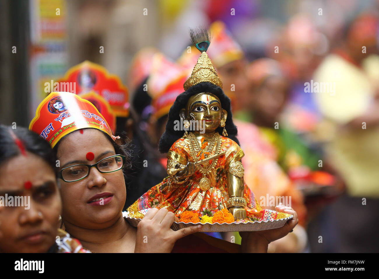 Hindu devotees hold the statue of Gopal Thakur as they attend a festival in old part of Dhaka ...