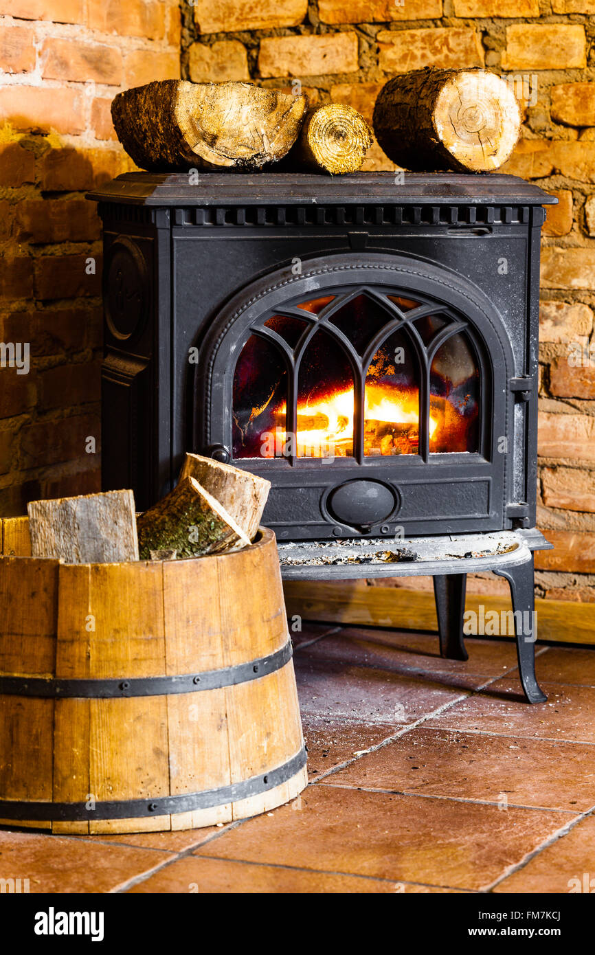 Winter at home. Closeup of fireplace with orange fire flame and ...