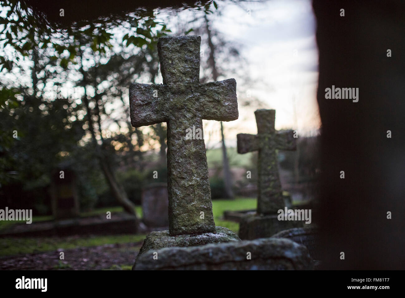 A church graveyard with stone memorials, crosses and gravestones Stock ...