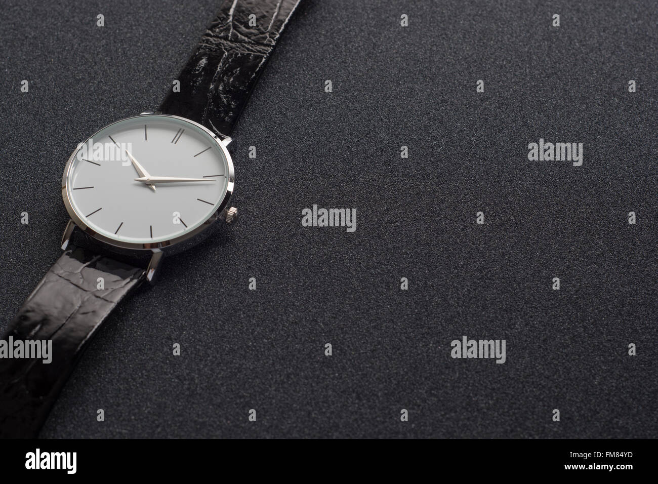 Watch on dark background Stock Photo - Alamy