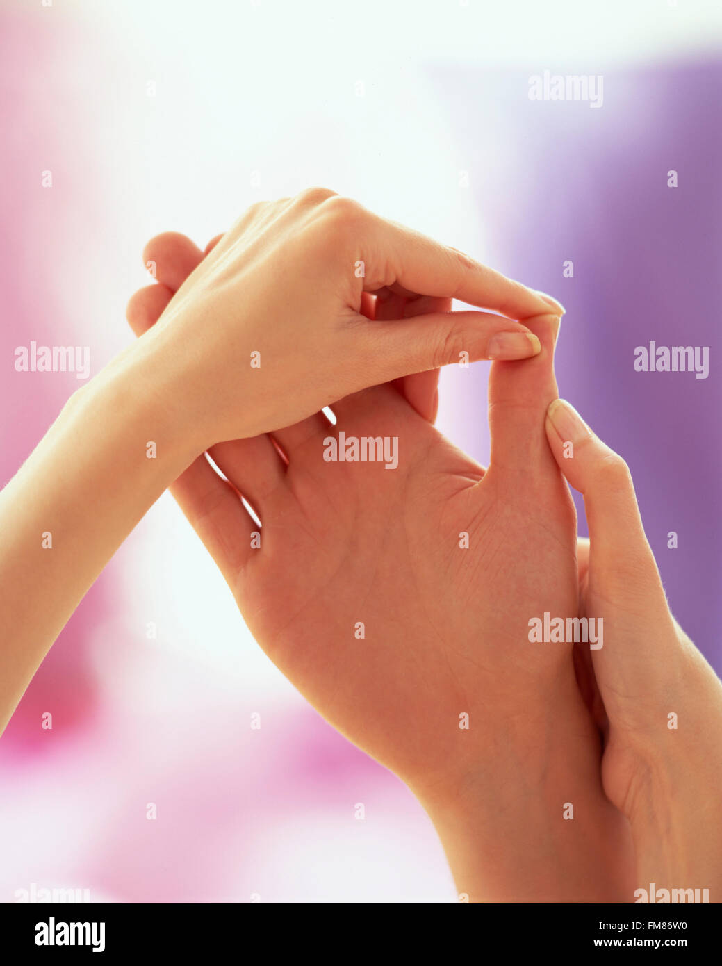 Holding hand upright with left working hand, holding thumb steady with ...