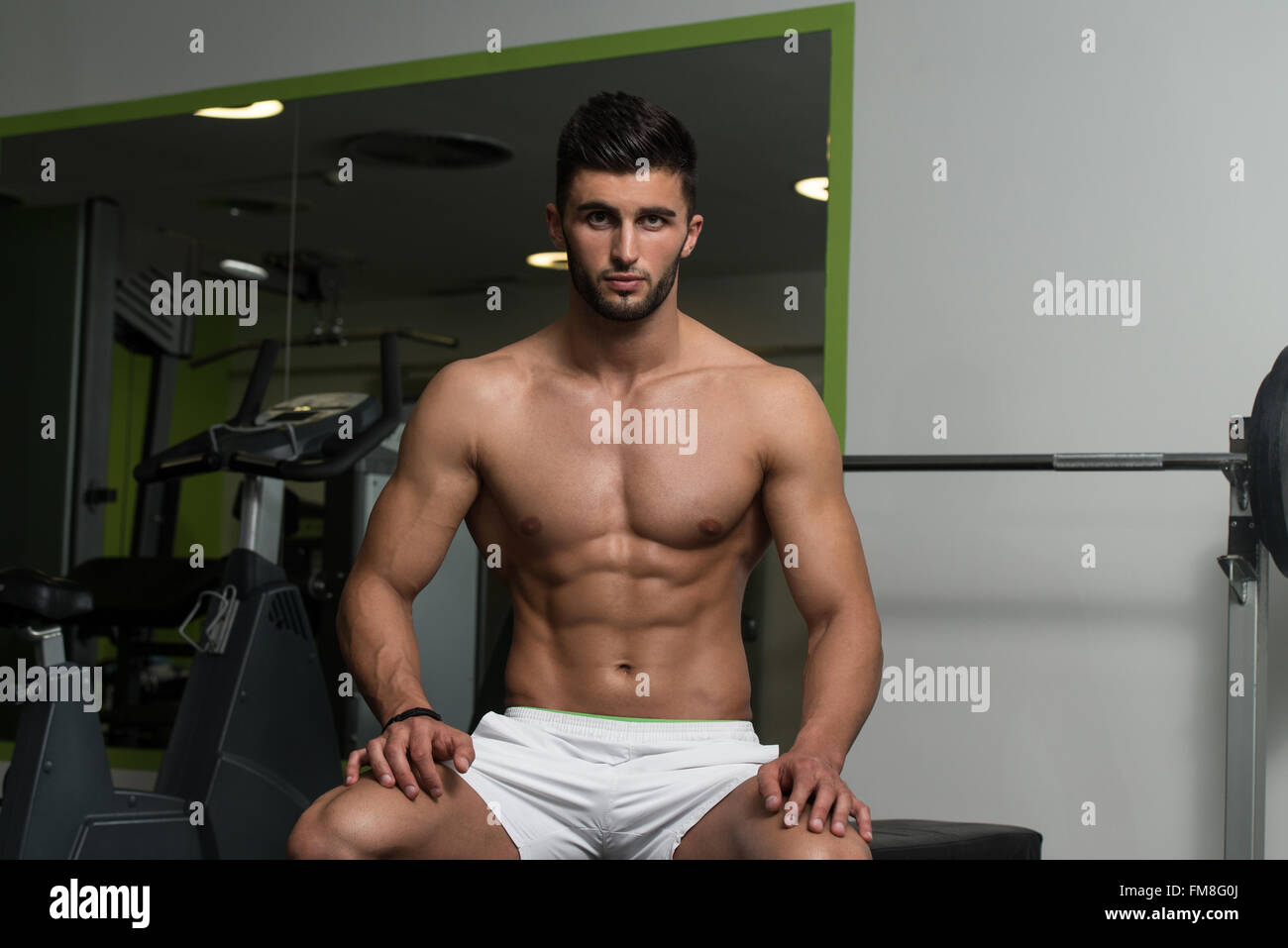 Portrait Of A Young Physically Fit Man Resting On Bench And Showing His ...