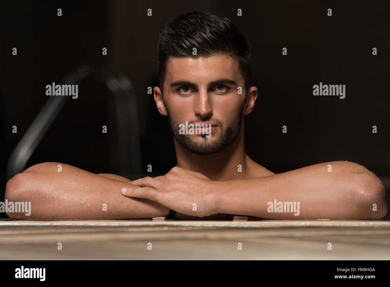 Happy Attractive Man Resting Relaxed On Edge Of Swimming Pool Stock ...