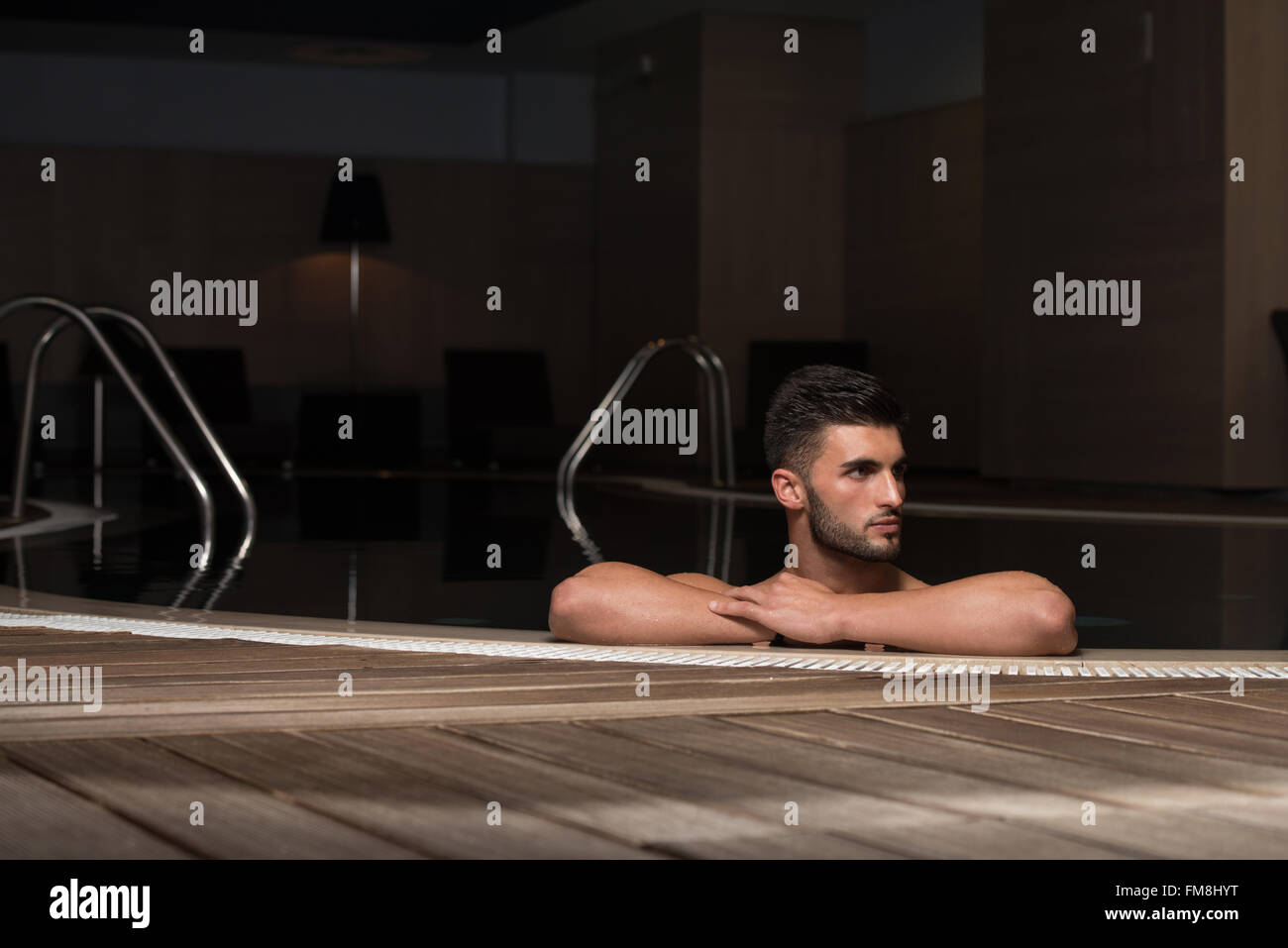 Happy Attractive Man Resting Relaxed On Edge Of Swimming Pool Stock ...
