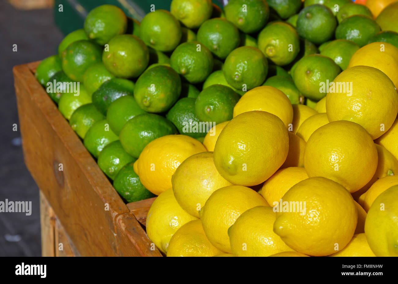 Fresh lemons and limes on display at market Stock Photo - Alamy