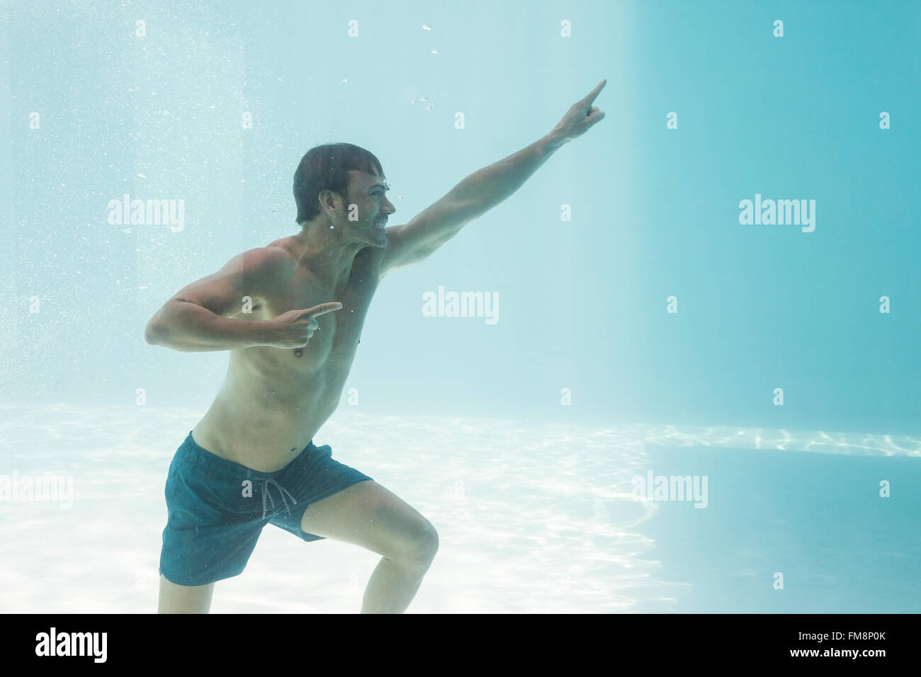 Man gesturing while standing underwater Stock Photo - Alamy