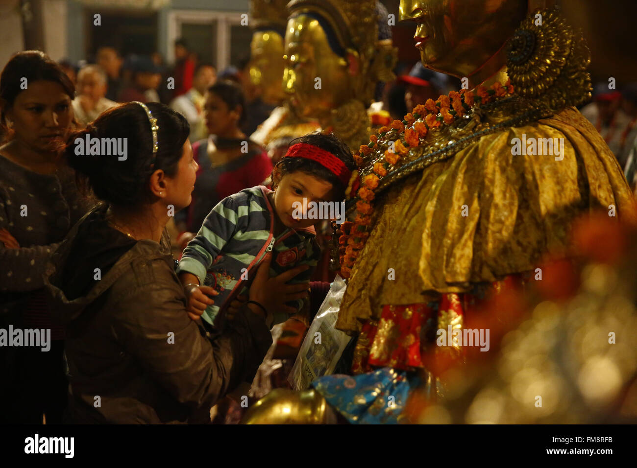 Lalitpur, Nepal. 11th Mar, 2016. A child offers prayer on the idol of ...