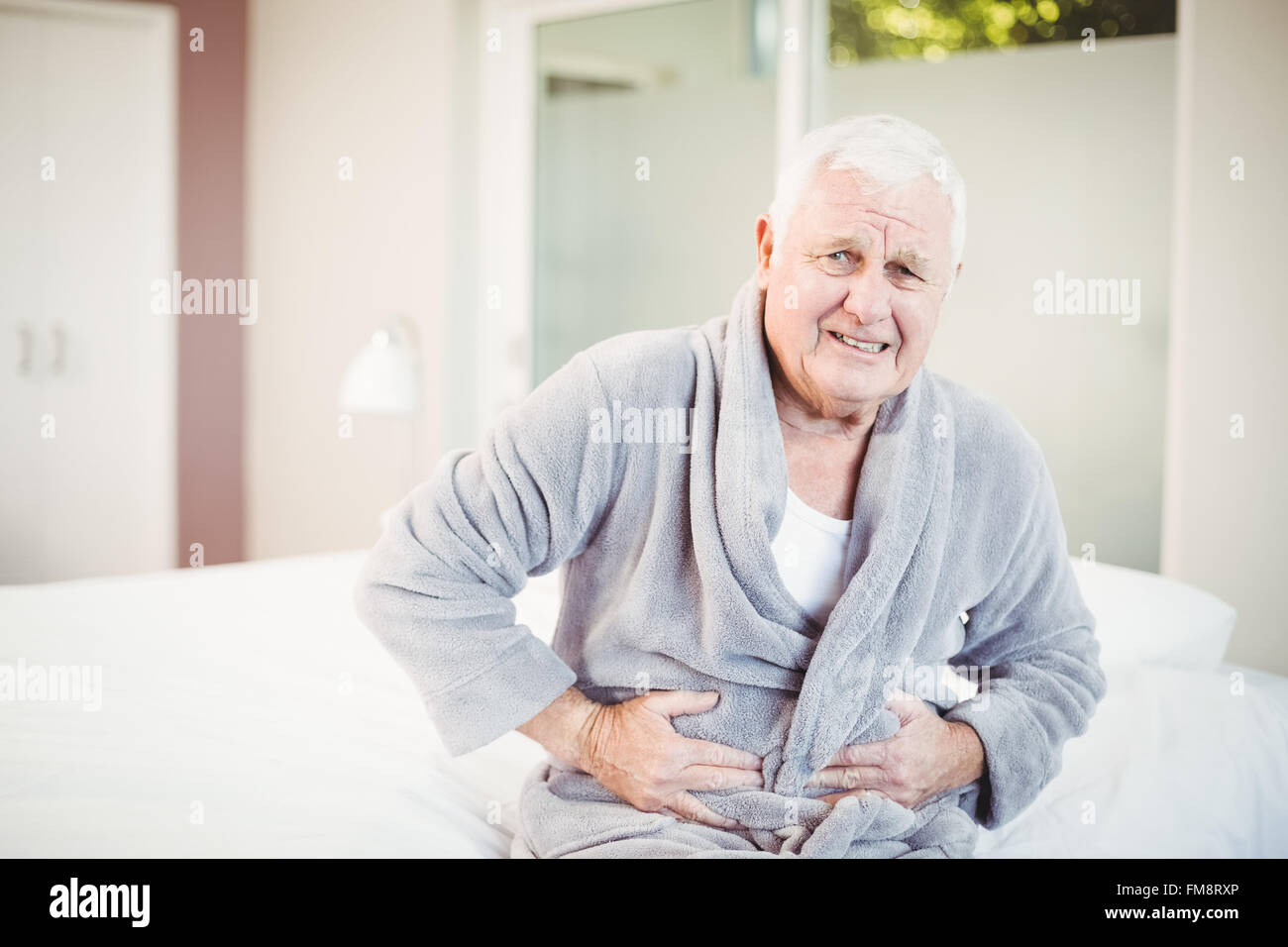Portrait of senior man frowning with stomach ache Stock Photo - Alamy Portrait of senior man frowning with stomach ache Stock Photo - Alamy