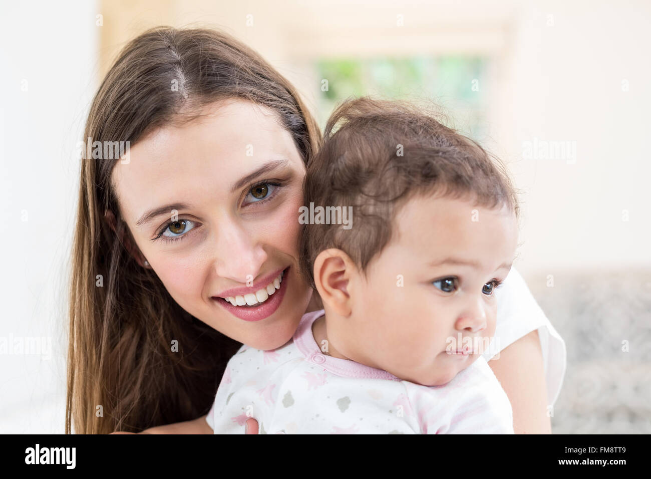 Portrait of smiling mother holding cute baby Stock Photo - Alamy