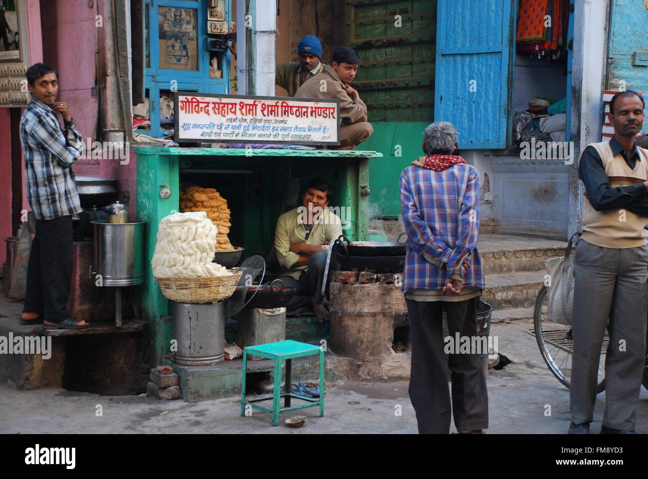 Happy sweet shop keeper in street stall in India Stock Photo - Alamy