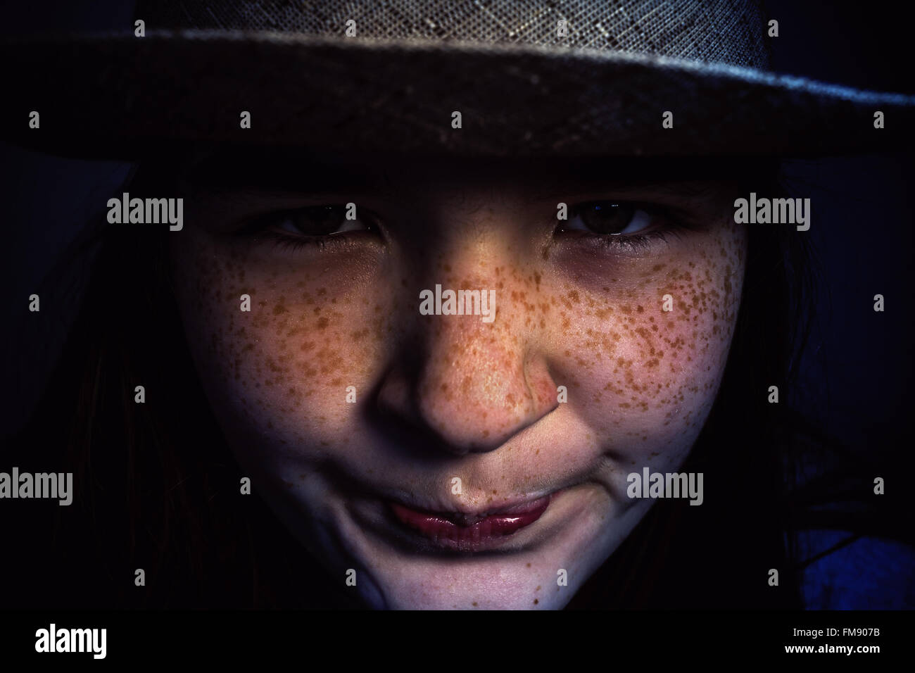 Portrait of a young girl with suspicious look Stock Photo - Alamy