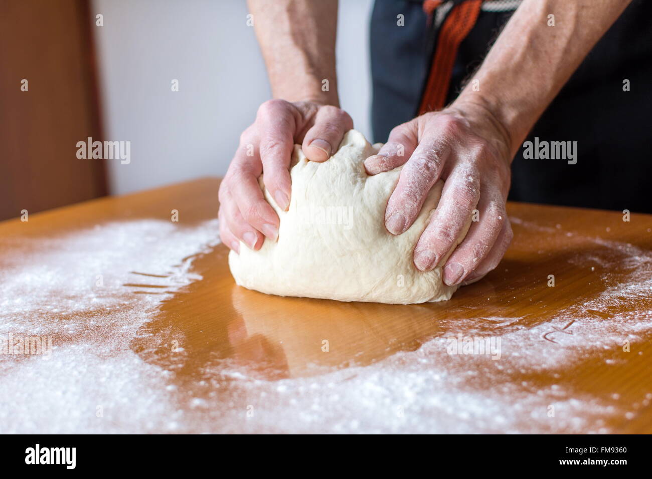 Male baker makes bread on the table Stock Photo - Alamy