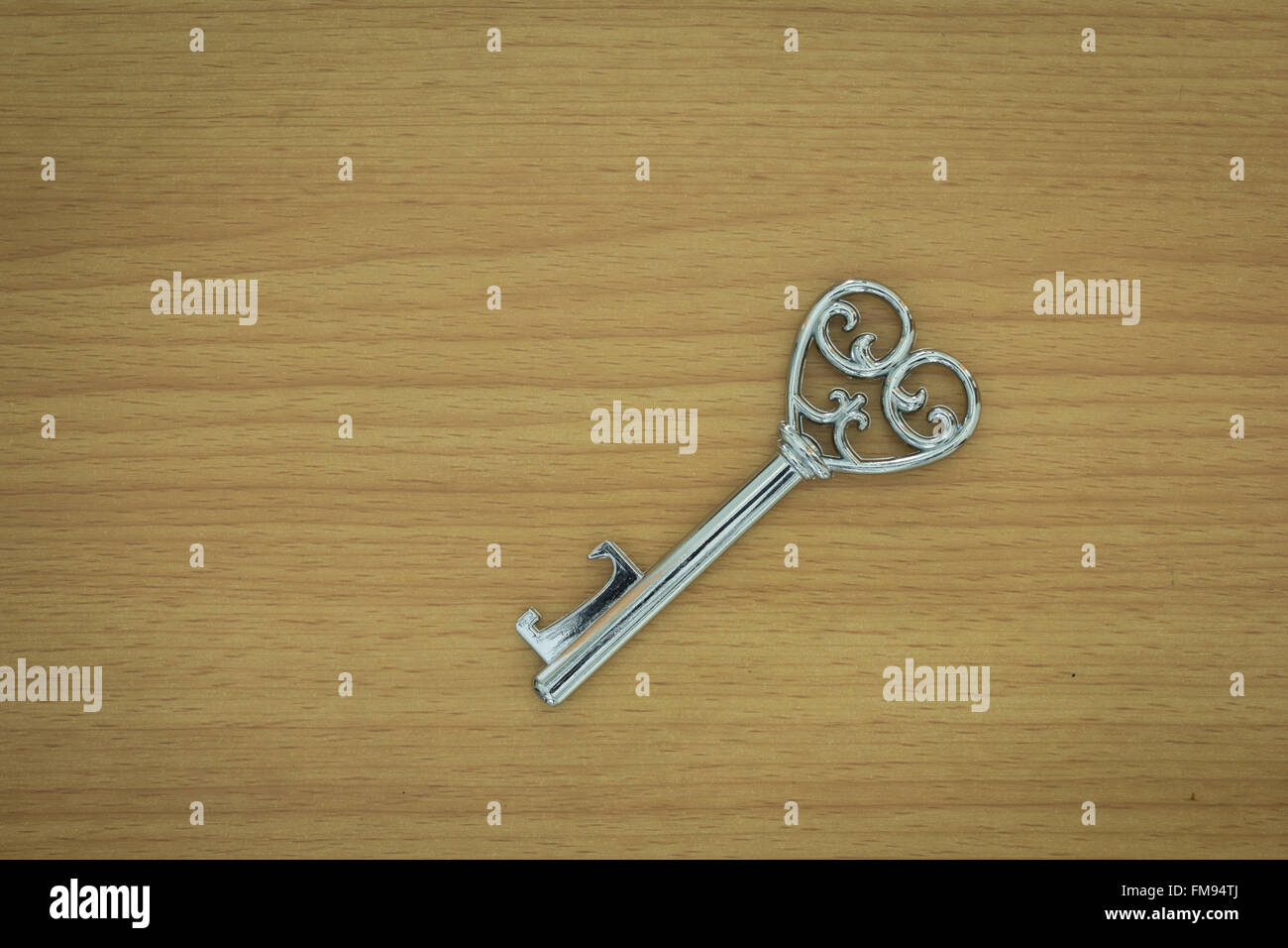 Heart shape key on a wooden background Stock Photo - Alamy